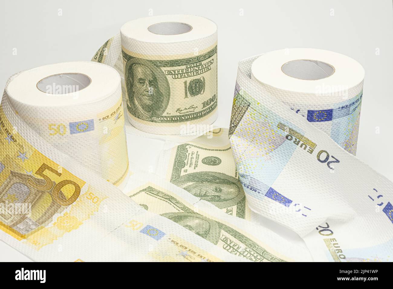 Rolls of bank notes toilet paper on white background Stock Photo - Alamy