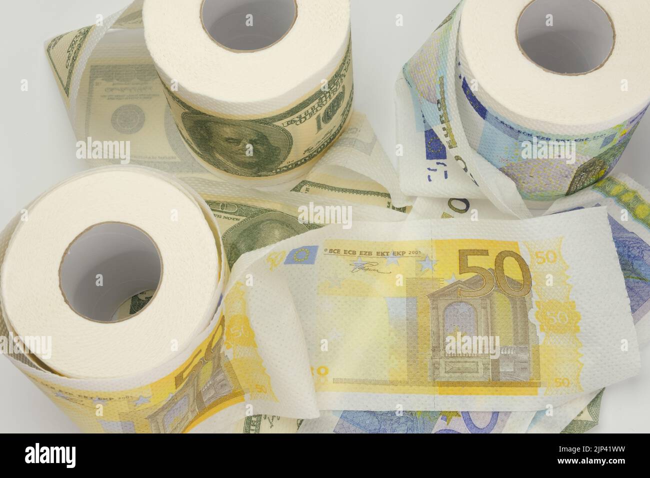 Rolls of bank notes toilet paper on white background Stock Photo - Alamy