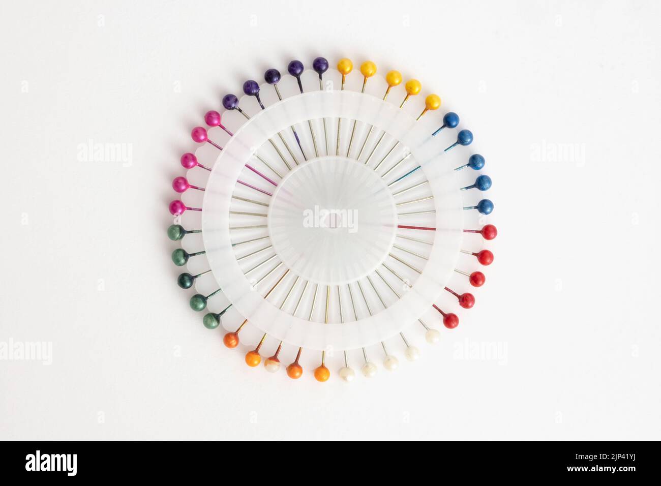 rainbow colored sewing needles in round circle packaging Stock Photo ...