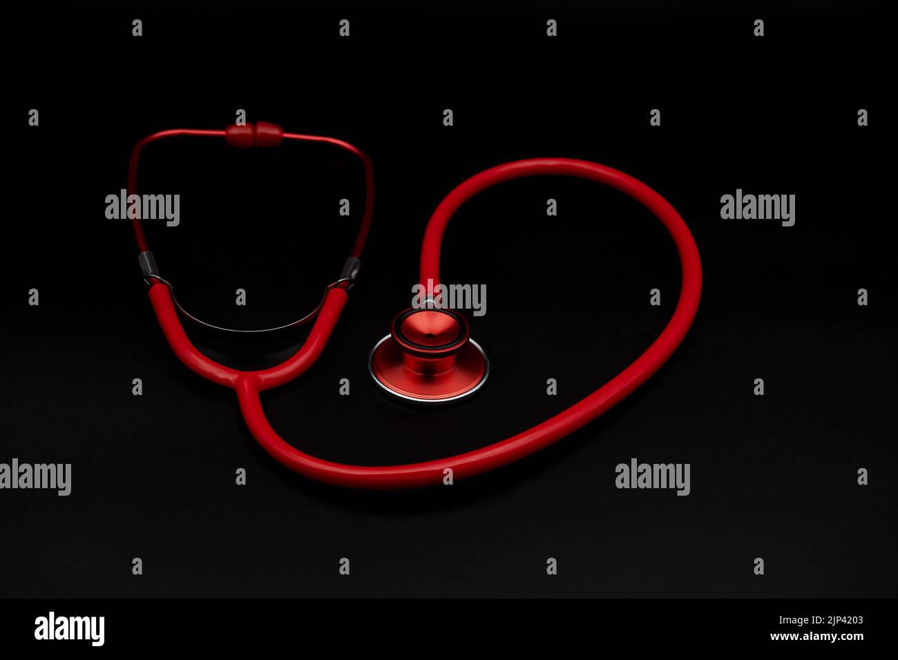 red stethoscope on dark background Stock Photo - Alamy