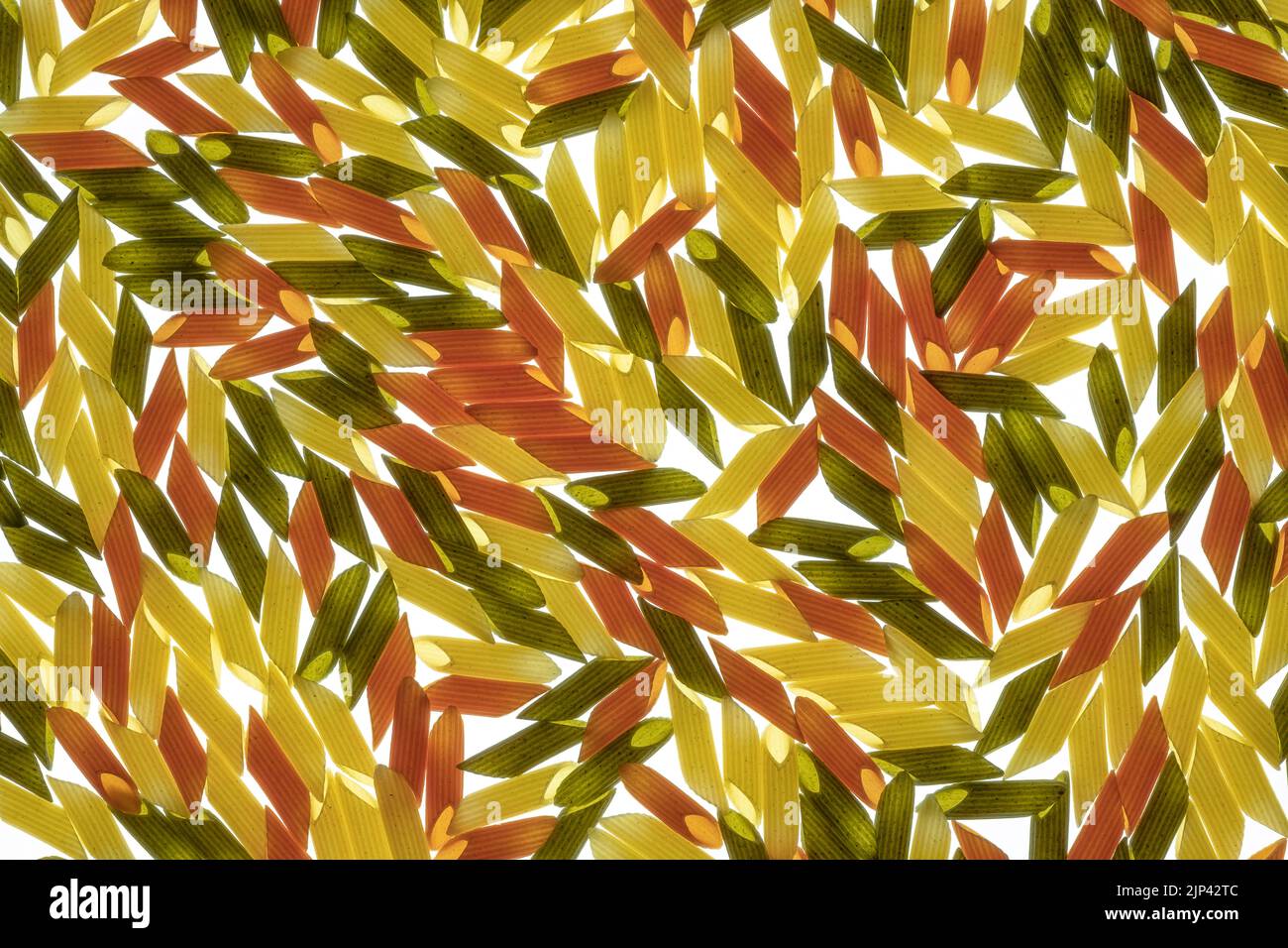 Tri-color penne pasta. Tomato, spinach and wheat pastas, rear lighting ...