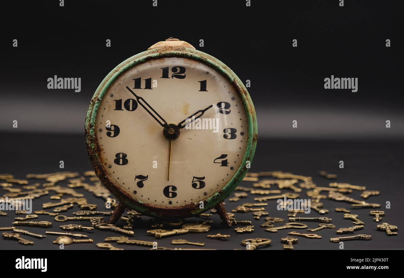 vintage table clock on ornamental keys background Stock Photo - Alamy