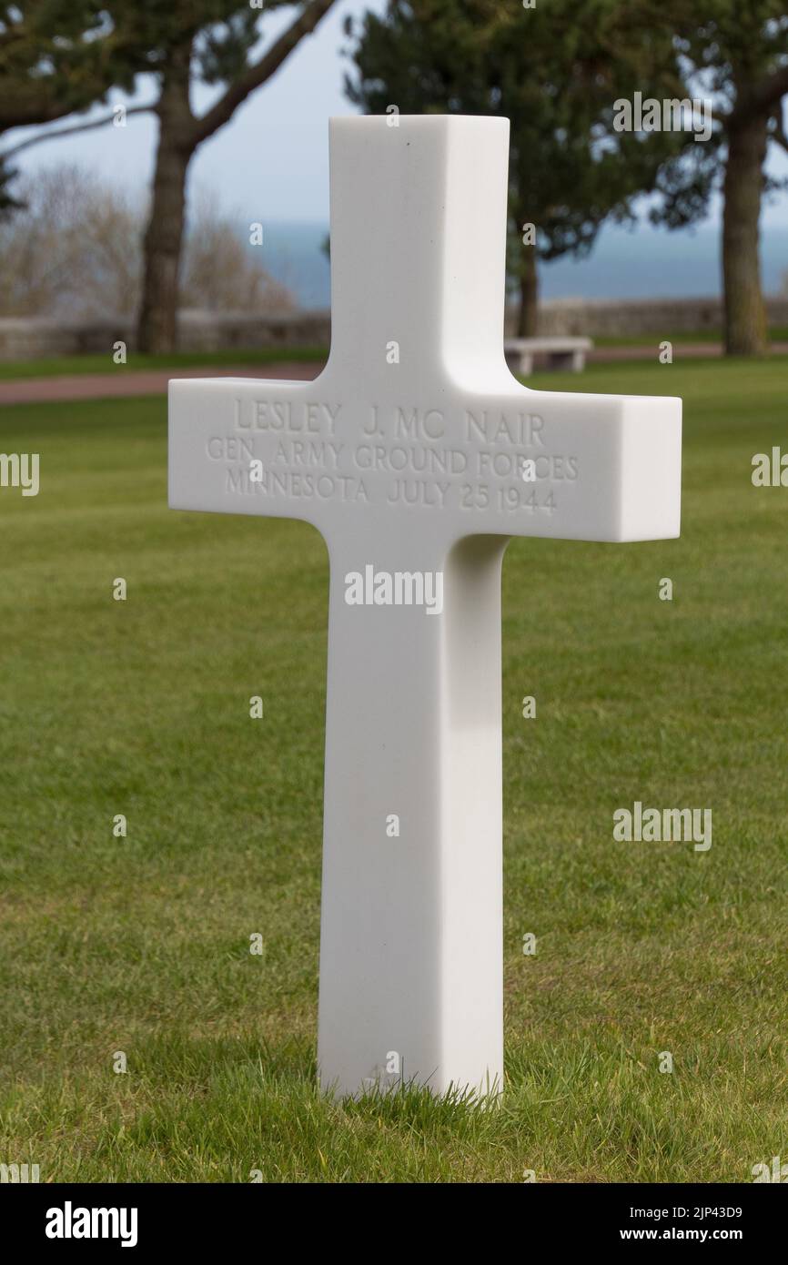 A vertical shot of a white cross tombstone in Normandy American ...