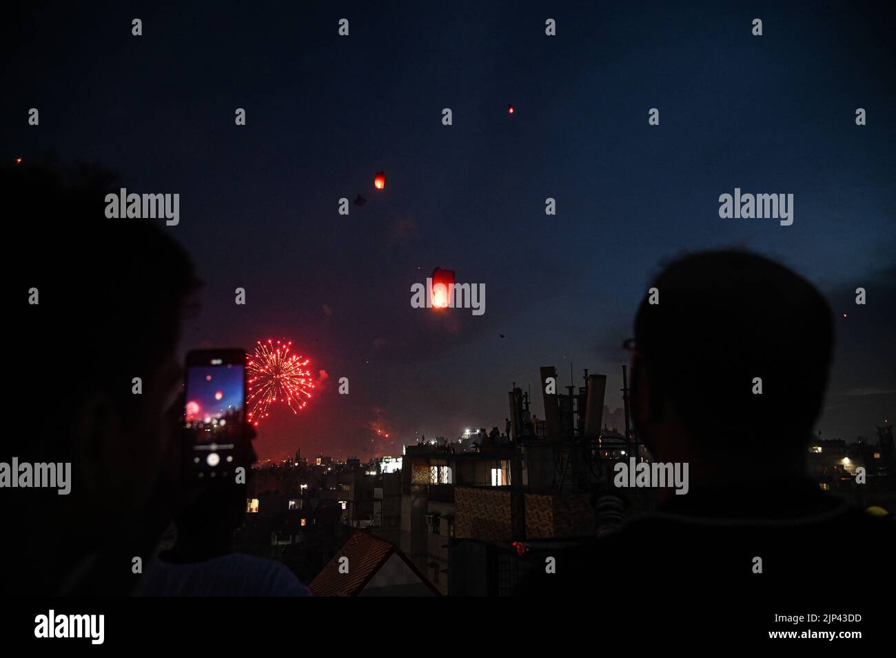 People watch as fire crackers burn from the rooftops to celebrate India ...