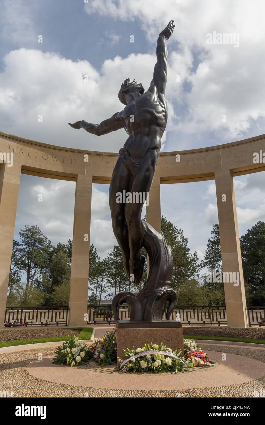 A vertical low angle shot of a male statue in the Normandy American ...