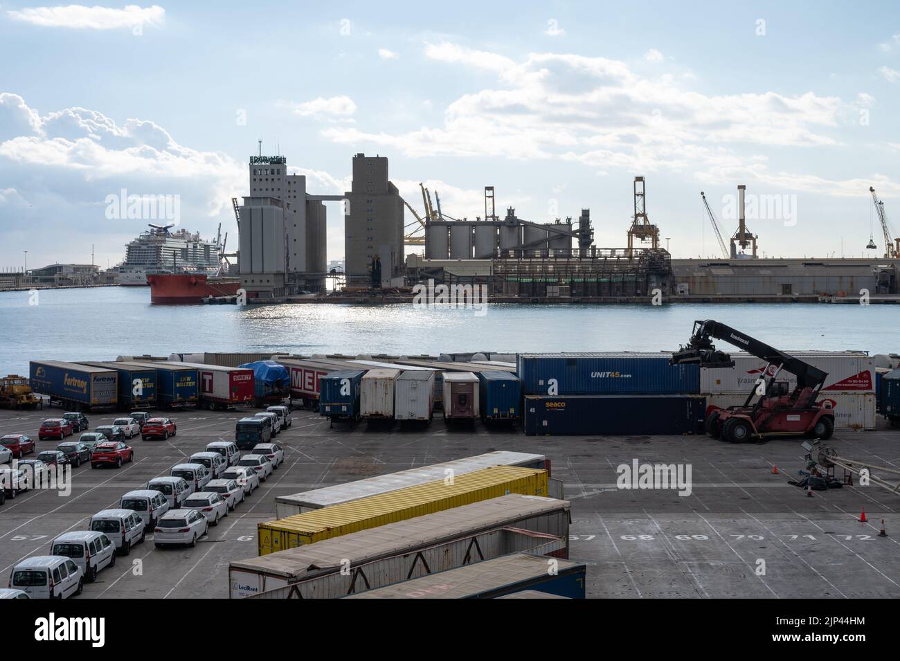 The port of Barcelona, loading and unloading dock with container trucks ...