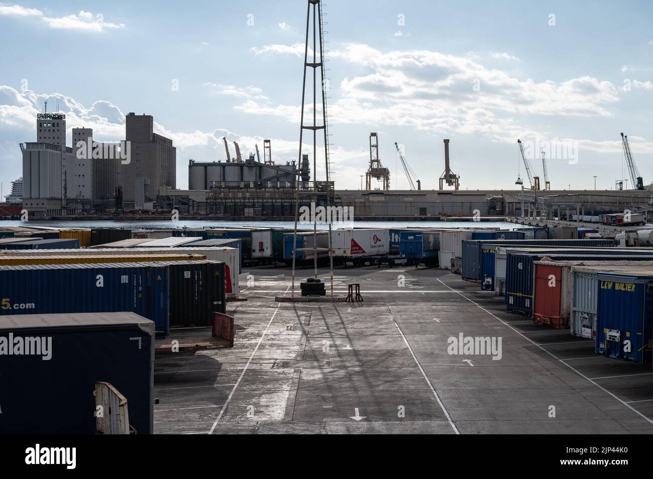 The port of Barcelona, loading and unloading dock with container trucks ...