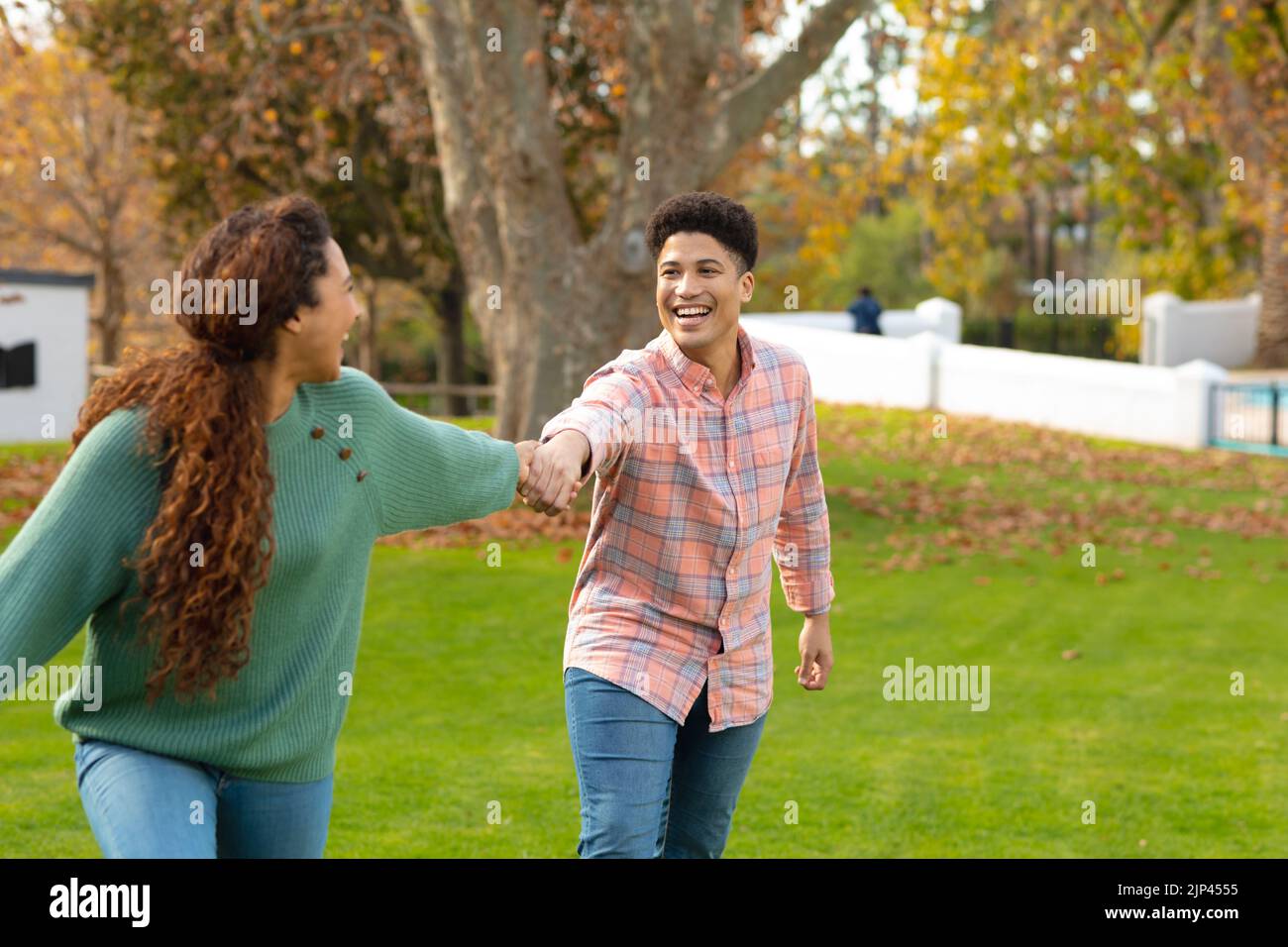 Happy biracial couple walking holding hi-res stock photography and images - Alamy