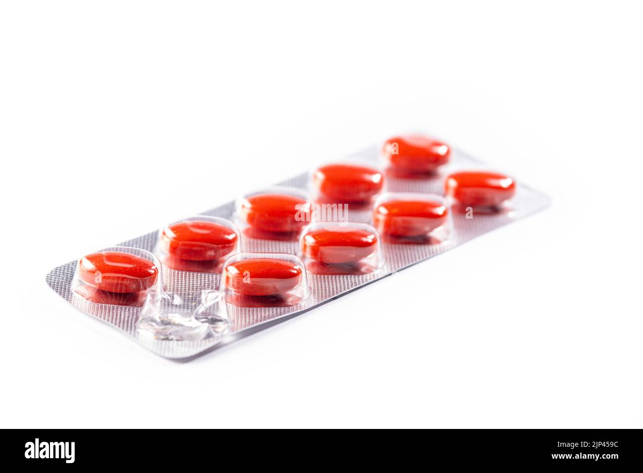 The red capsules in silver blister pack with one missing isolated on ...