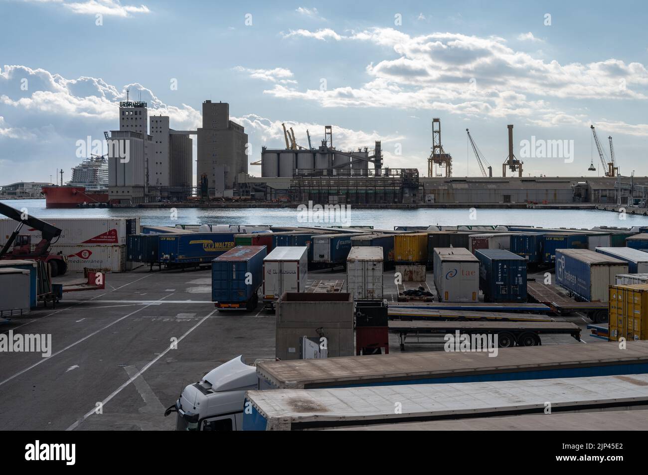 The port of Barcelona, loading and unloading dock with container trucks ...