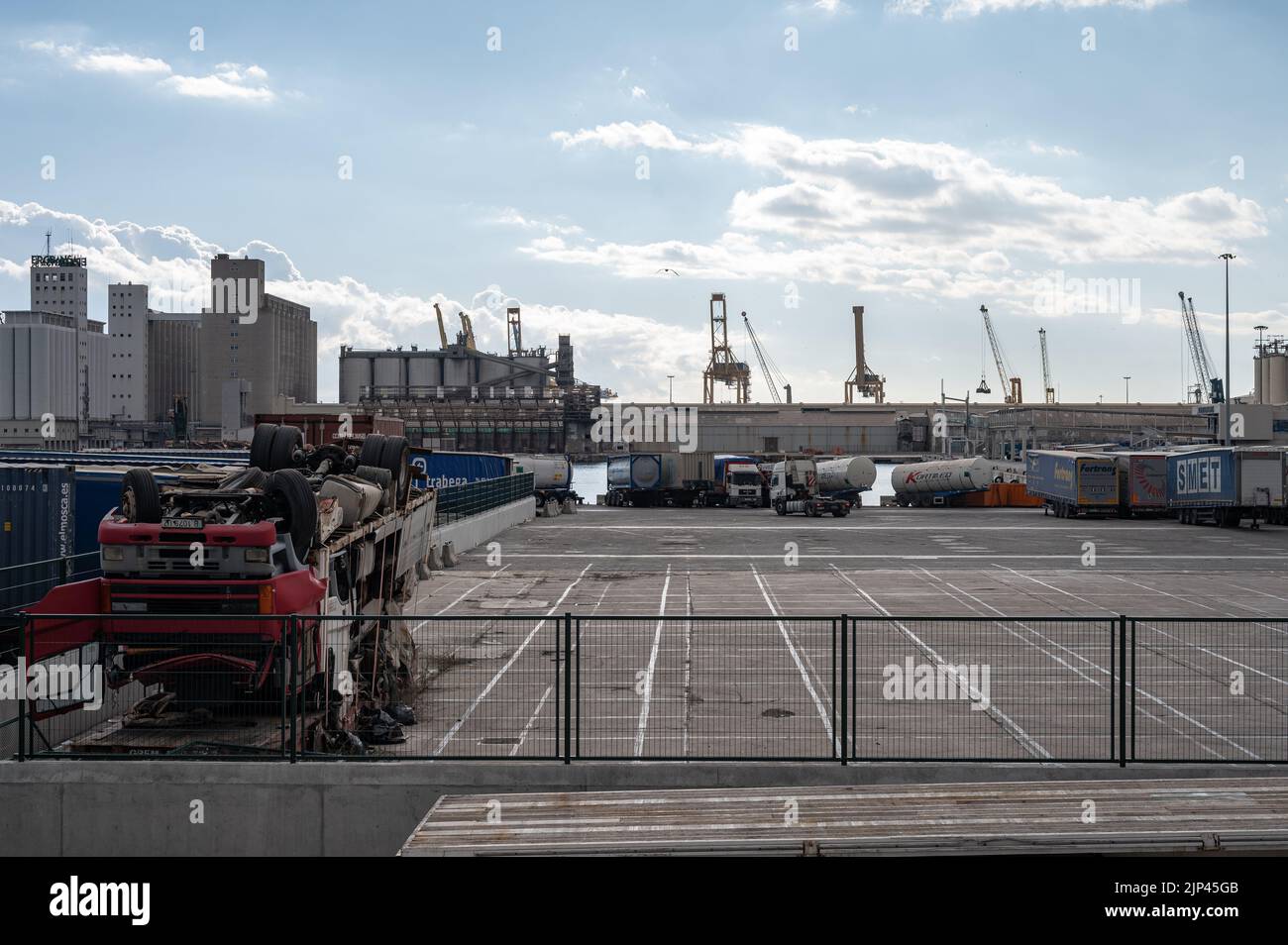 The port of Barcelona, loading and unloading dock with container trucks ...