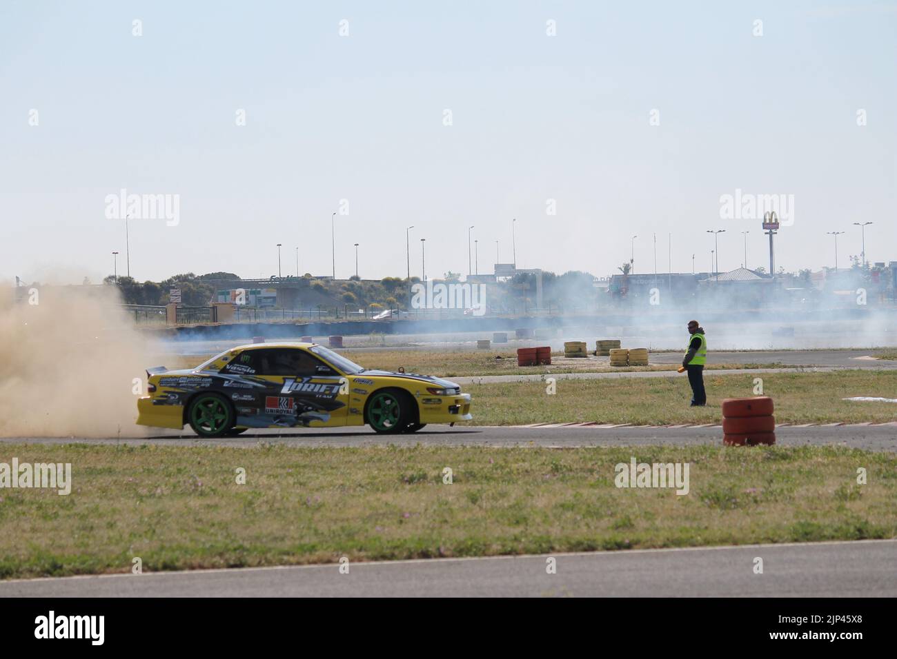 A drifting stylish yellow car a highway background Stock Photo - Alamy