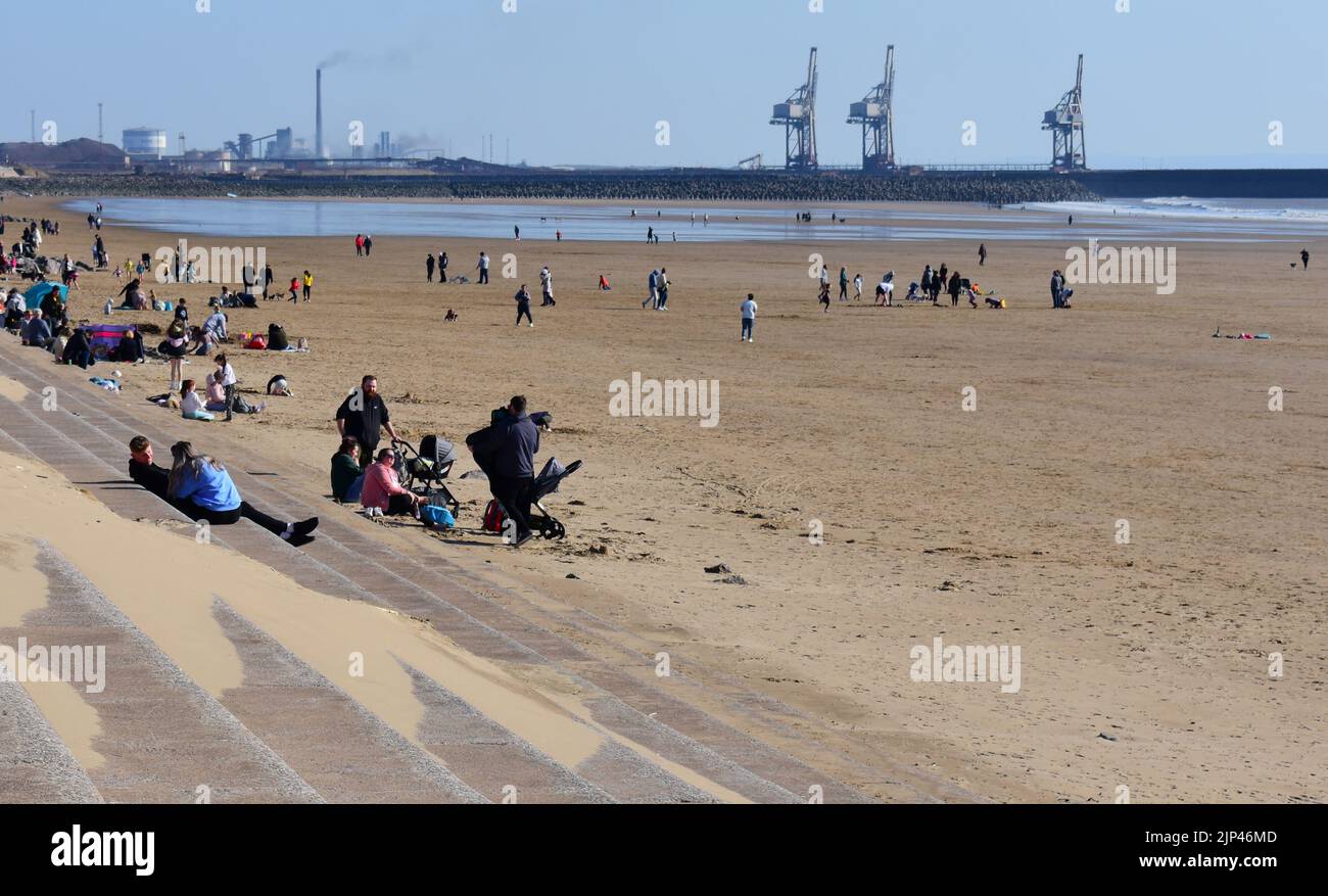 People on the beach and promenade at Aberavon Beach at low tide in ...