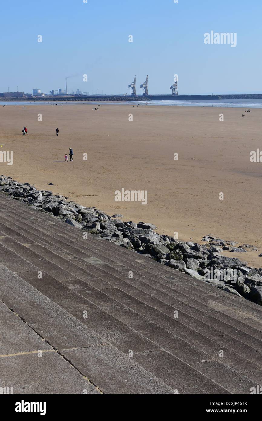 People on the beach and promenade at Aberavon Beach at low tide in ...