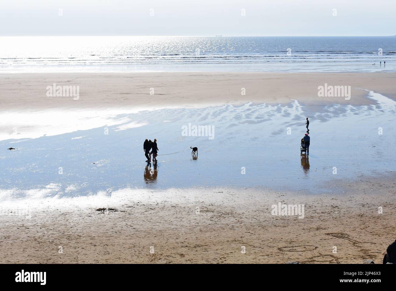 People paddle in pools left by yhr receding tide at Aberavon Beach near ...