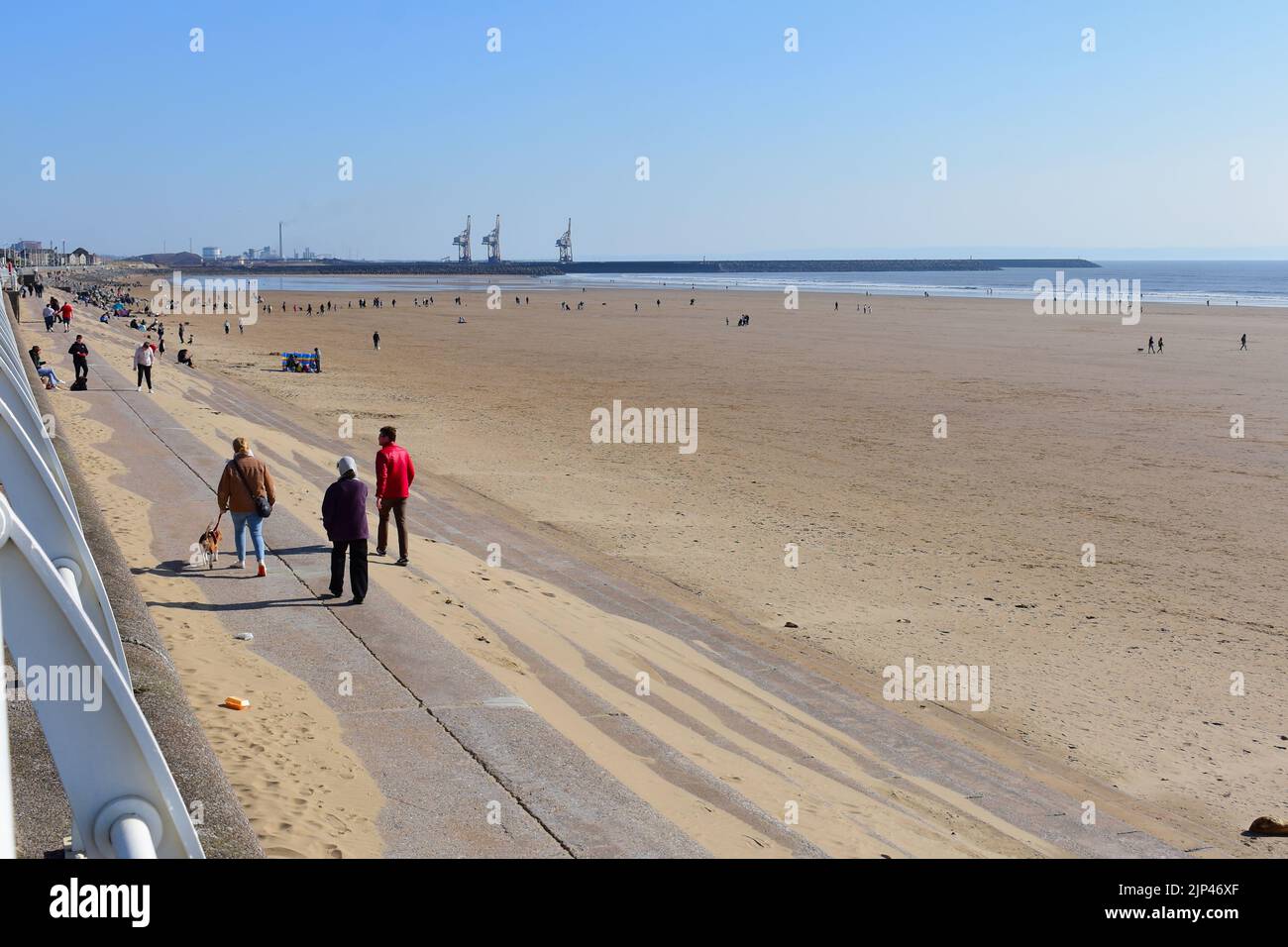People on the beach and promenade at Aberavon Beach at low tide in ...