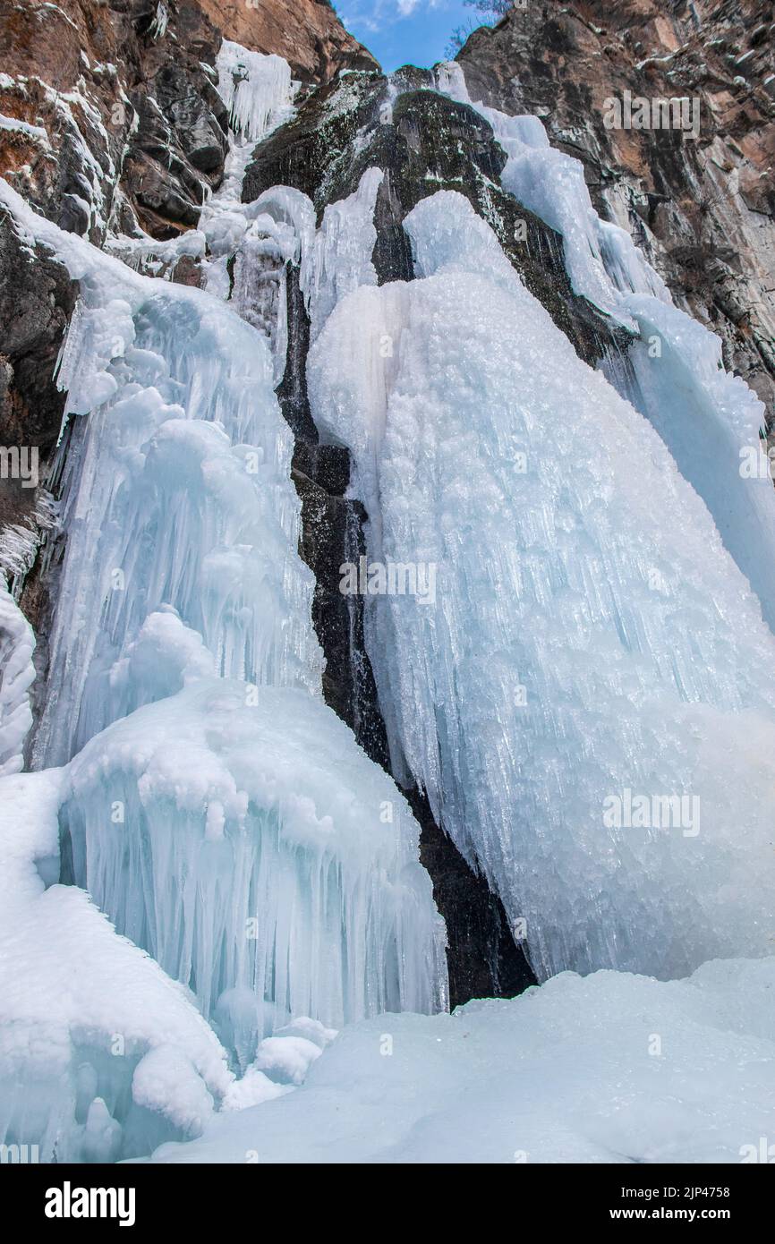 Frozen waterfall in the mountains of the Zailiyskiy Alatau in Central ...