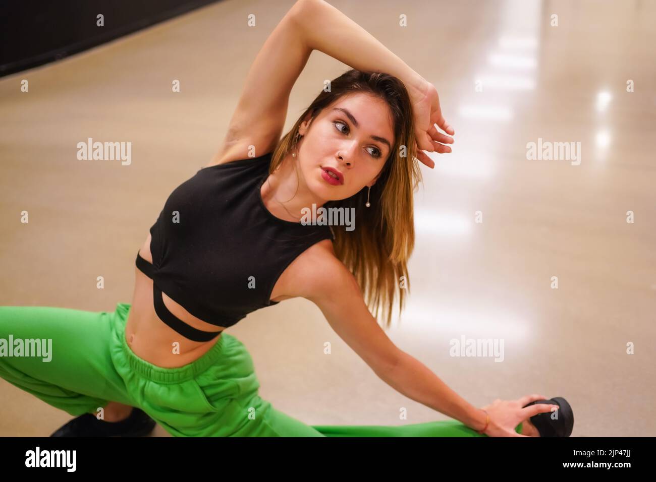 An adult female hip-hop dancer in a stretching position Stock Photo - Alamy