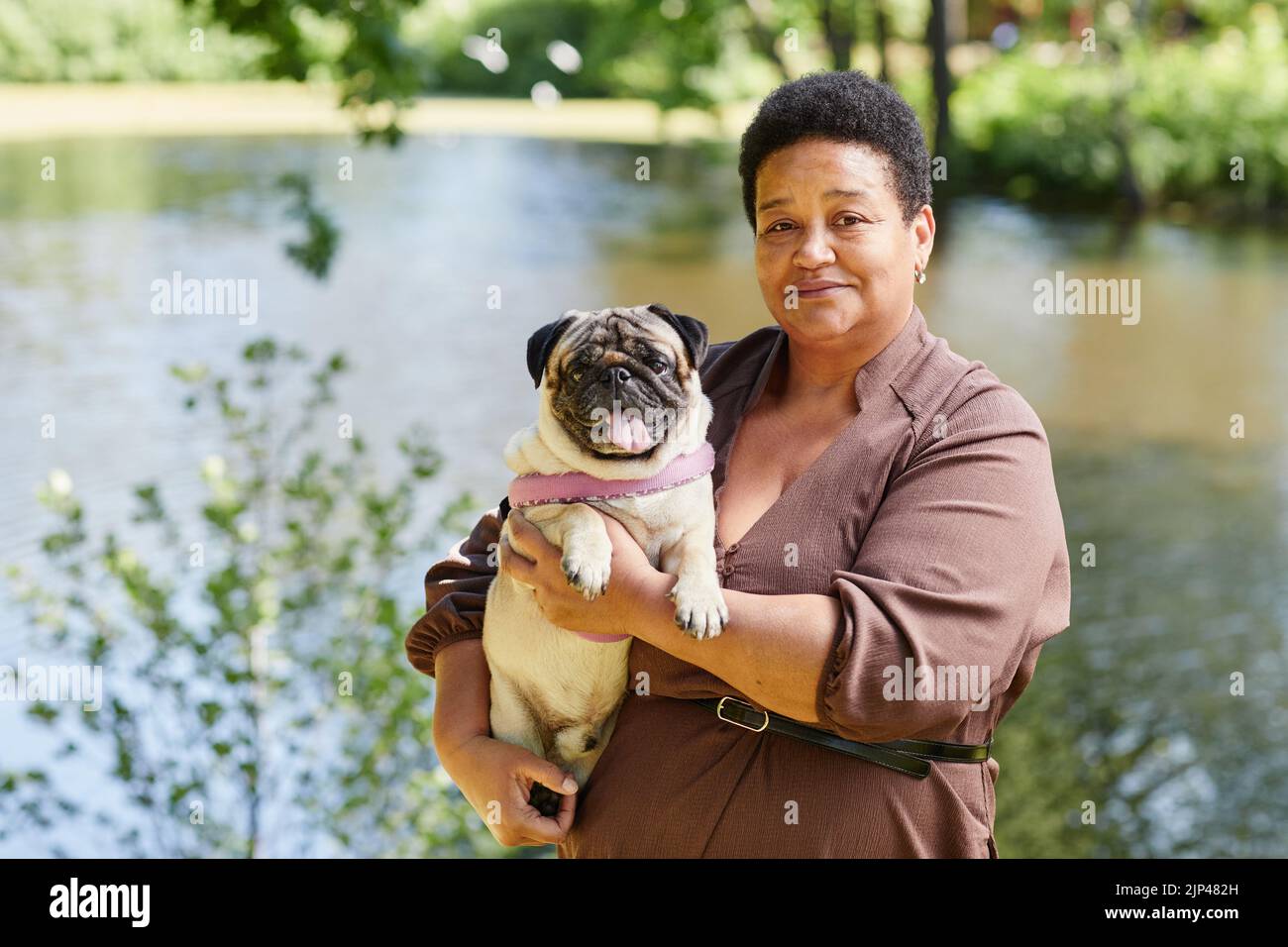 Woman holding pet pug hi-res stock photography and images - Alamy