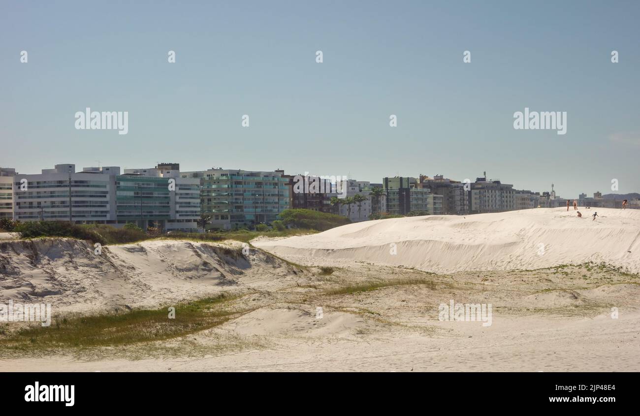 Sand dunes and beachfront buildings at Forte beach. Cabo Frio, Rio de ...