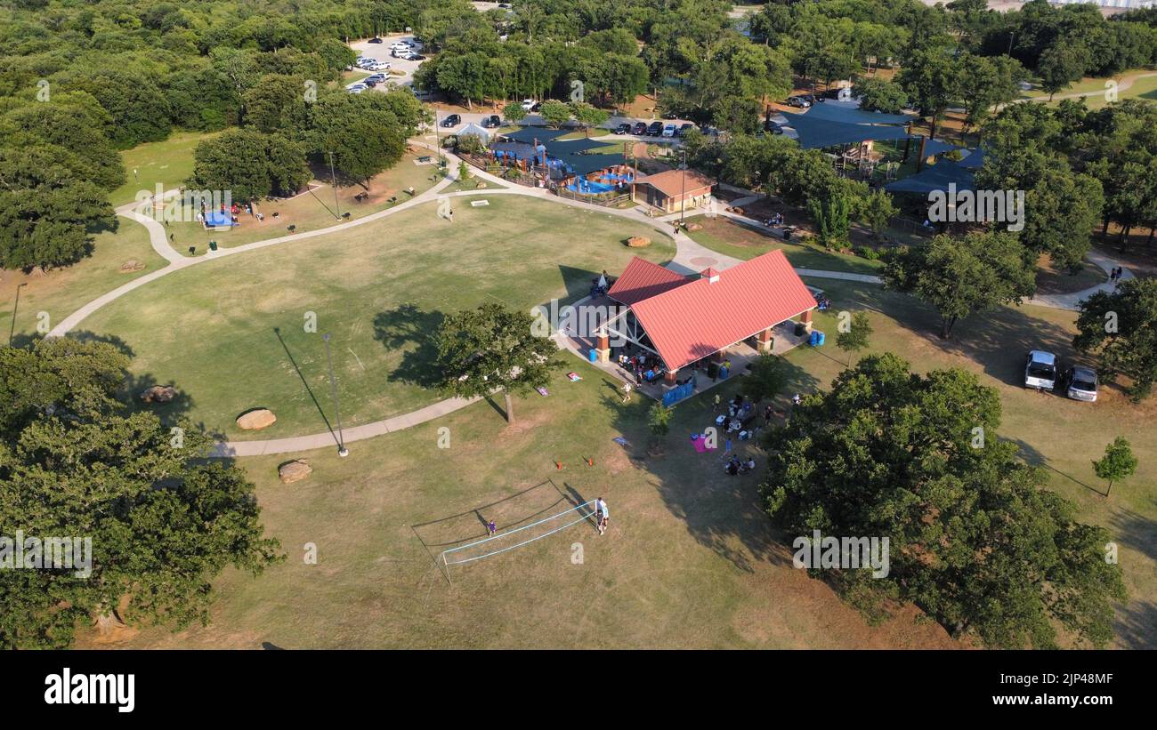 A bird's eye view of a camp complex with green fields and playgrounds ...