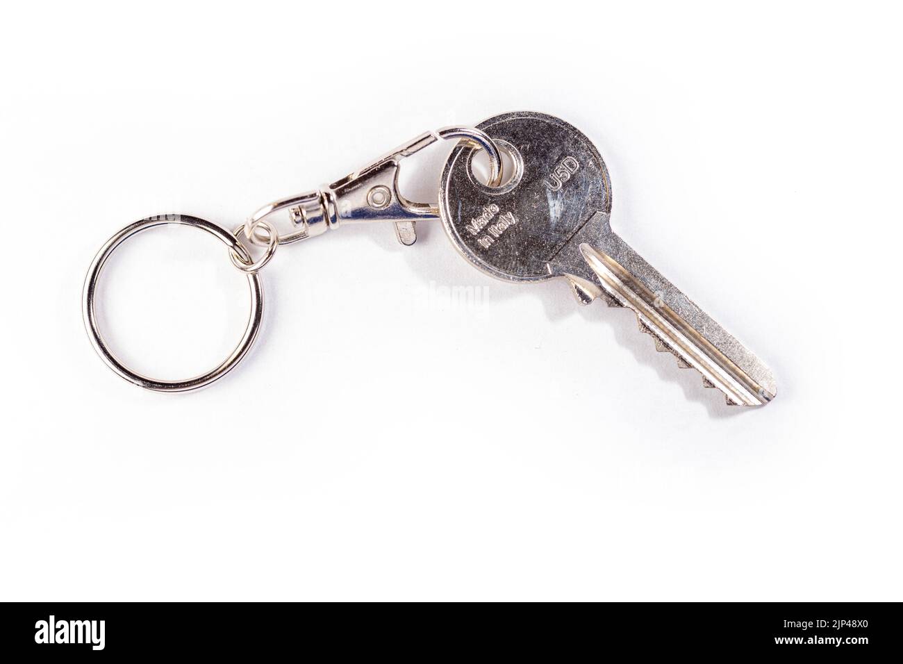 A silver key with chain isolated on white background Stock Photo - Alamy