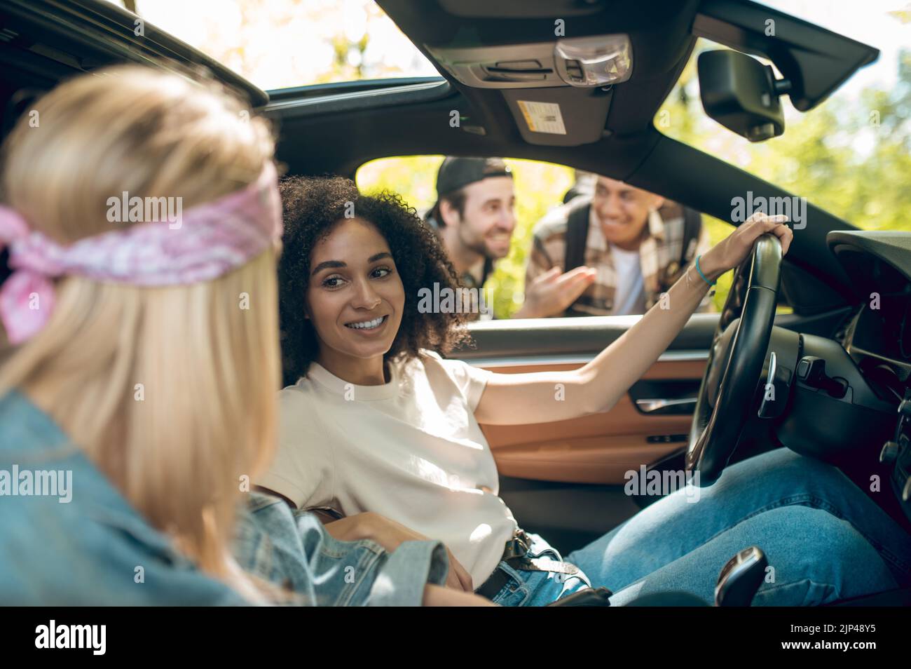 Girls in the car flirting with men on the road Stock Photo - Alamy