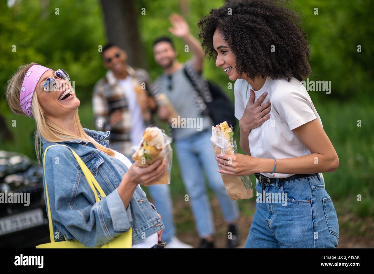 Group young friends eating sandwiches hi-res stock photography and ...