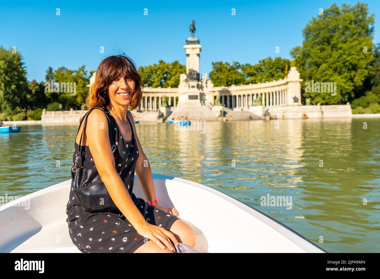 A smiling Caucasian female tourist in the boat of the Estanque Grande ...