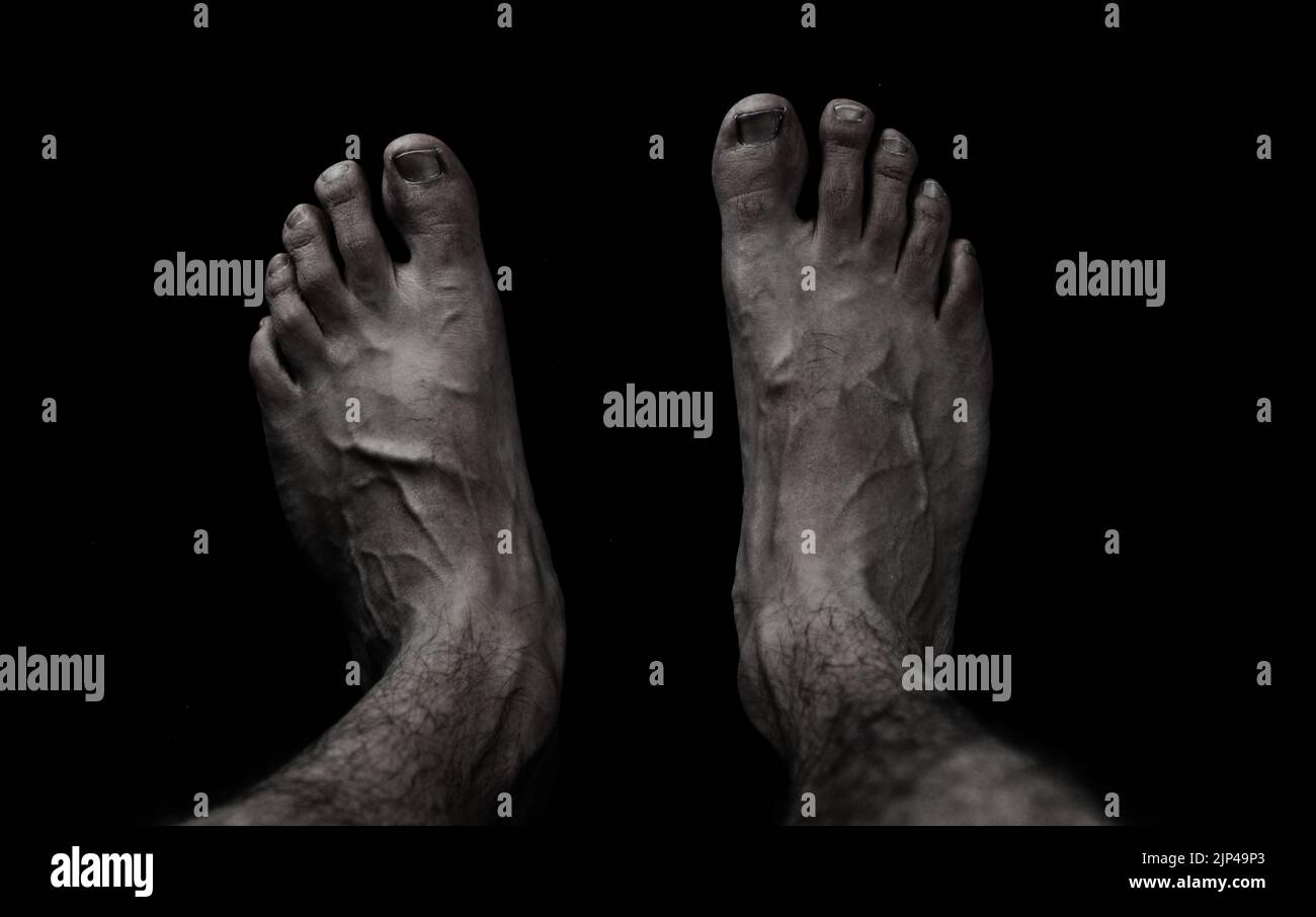 The feet of a male person with visible veins on a black surface Stock ...