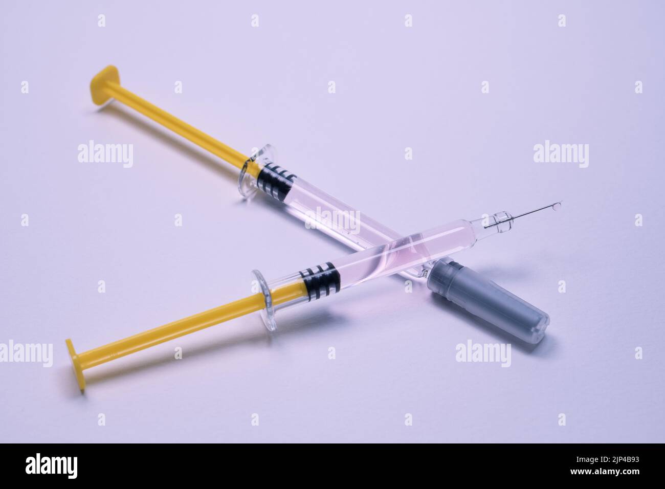 Different syringes on white table prepared for injection in the ...