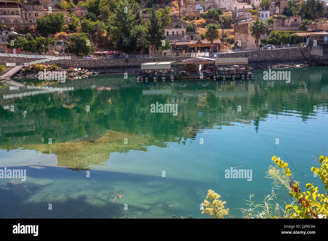 The reflection of the Sanliurfa sunken city in the water reservoir ...