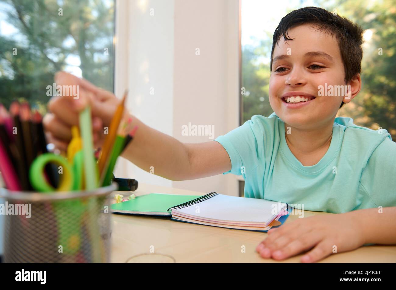Portrait ofadorable schoolchild, European boy smiling a cheerful toothy ...