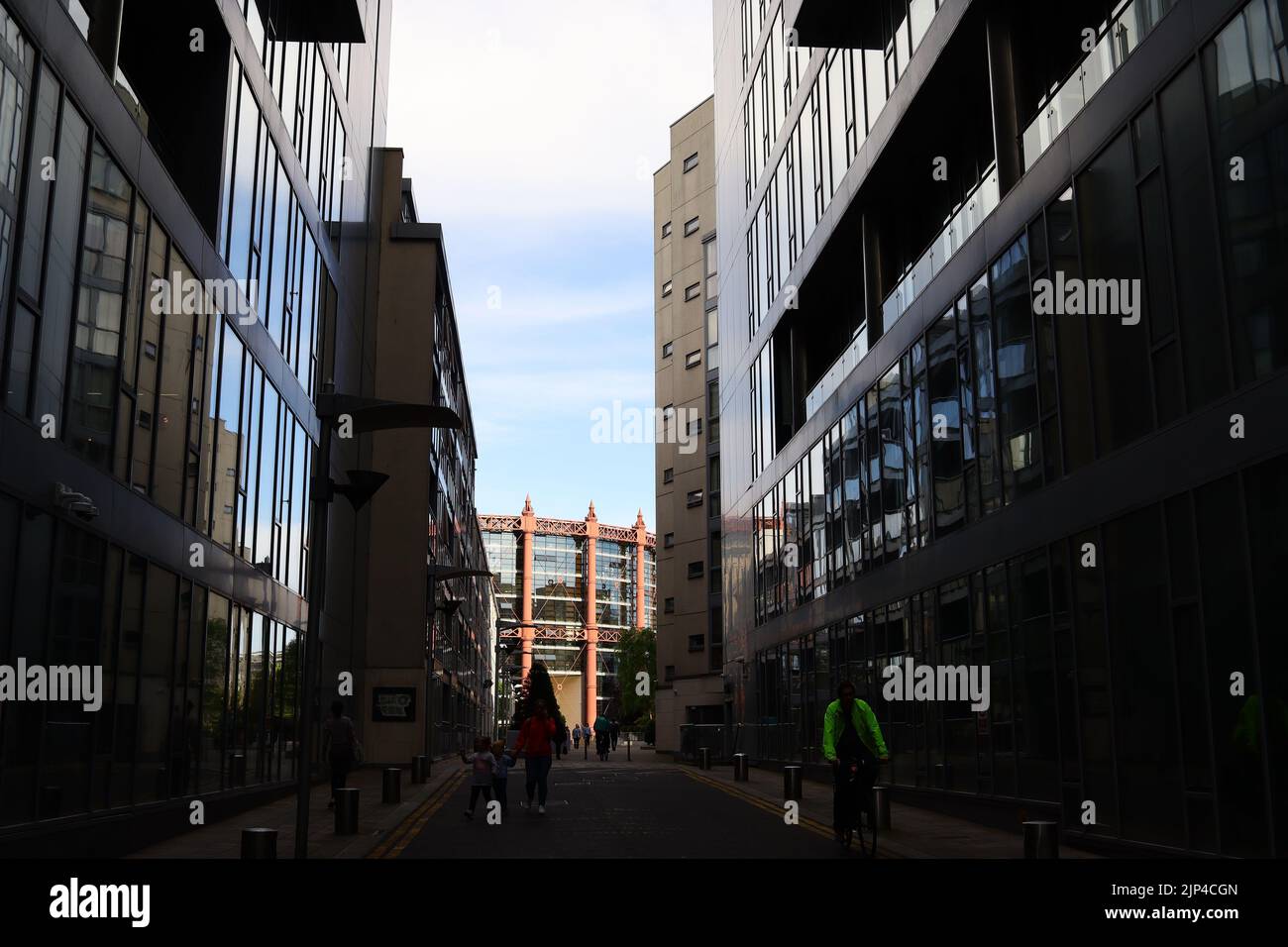 A street between modern buildings with the reflection on the facade and ...