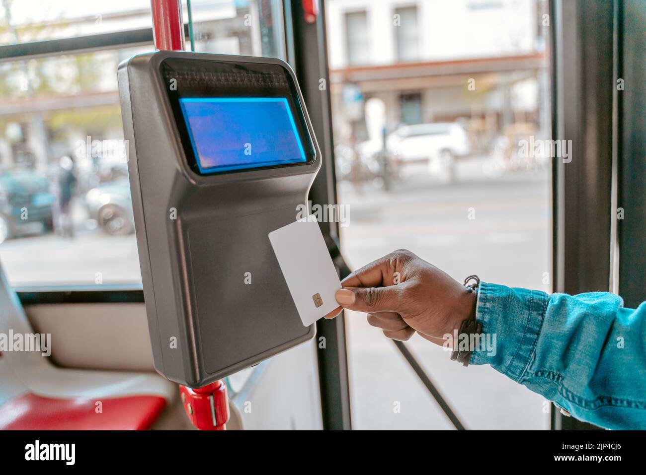 Hand holding card near reader in bus Stock Photo - Alamy