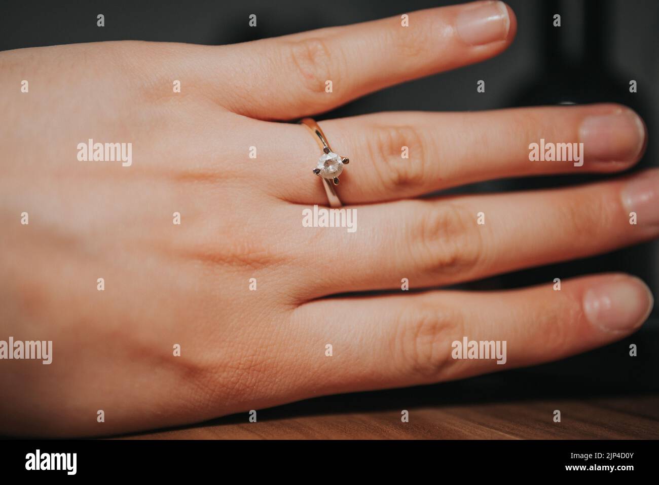 A close-up shot of an engagement ring on a finger Stock Photo - Alamy