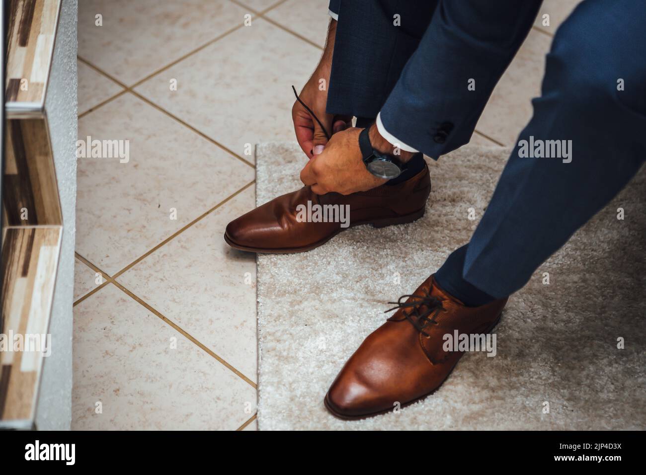 A person tying his classic leather shoes Stock Photo - Alamy
