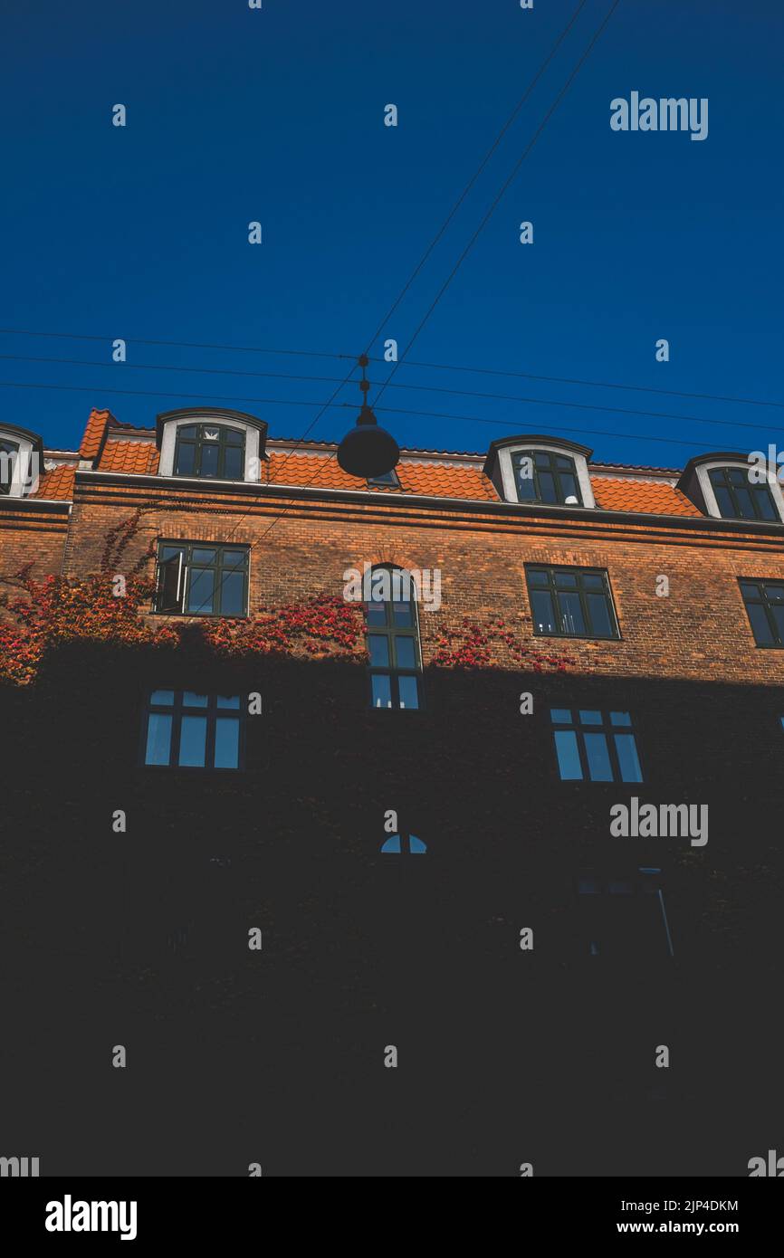 A vertical low angle shot of shadows on the facade of a building in ...
