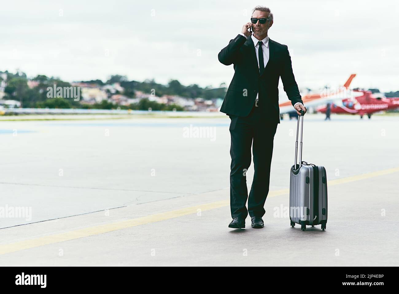 Let me call you back, Im about to board. Full length shot of a handsome ...