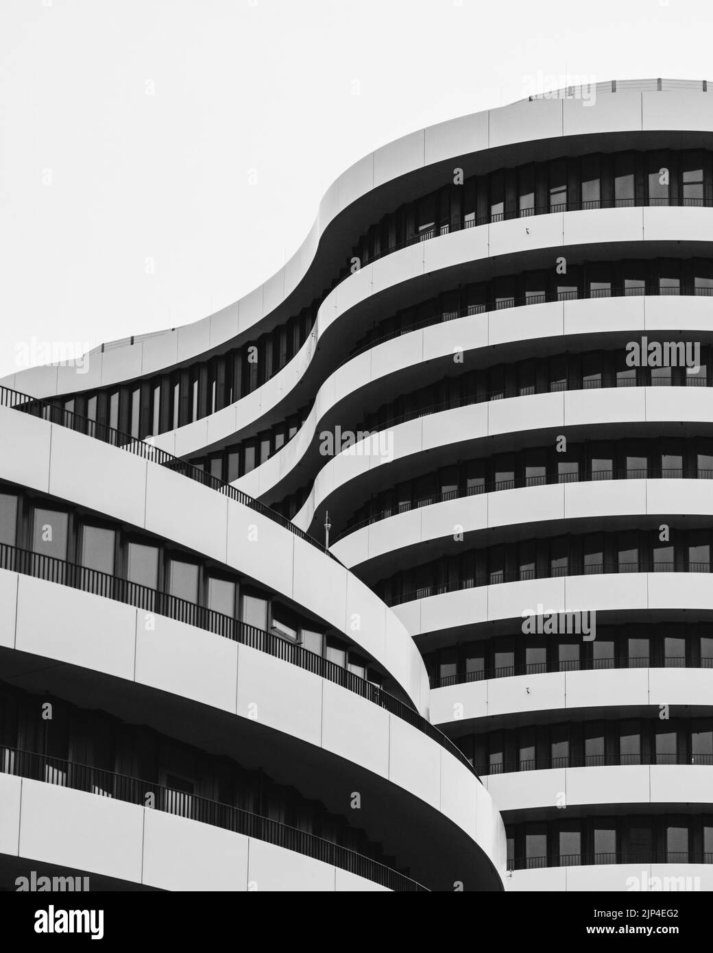 Curvy Shaped Buildings merging with the sky Stock Photo - Alamy