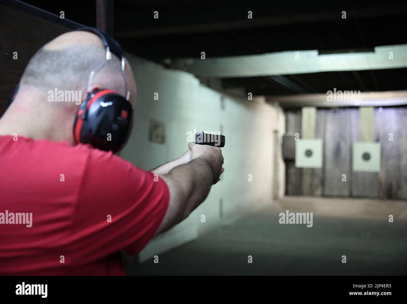 Man Weapon bullseye target training in a shooting club Stock Photo - Alamy