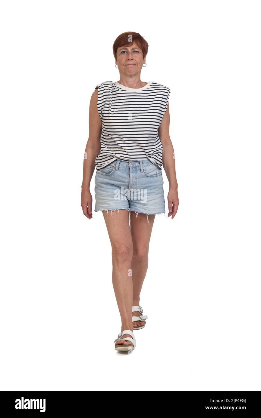 front view of a full portrait of a middle aged woman walking on white ...
