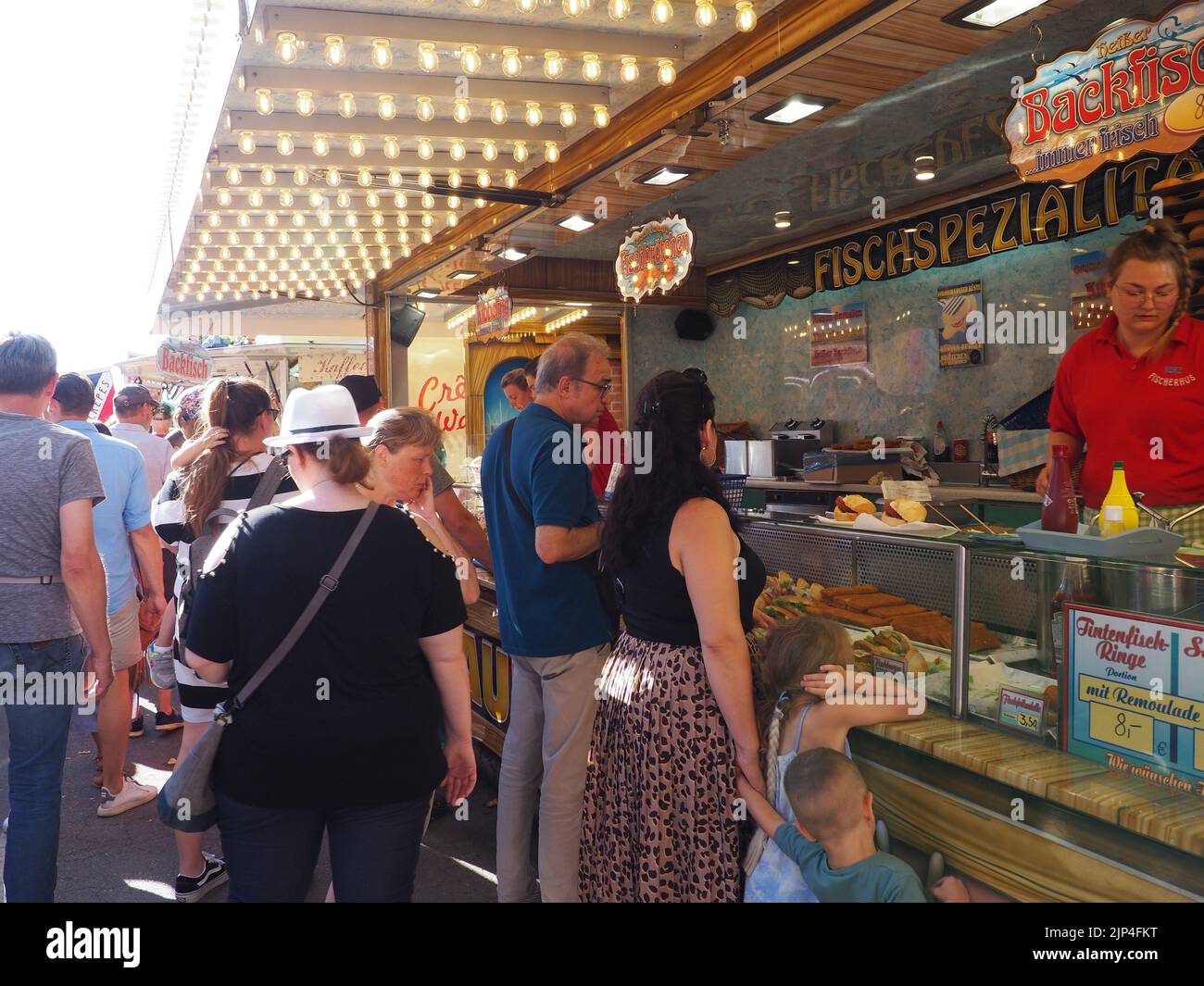 A family standing at a stall selling fish during the Rhenish Fisher ...