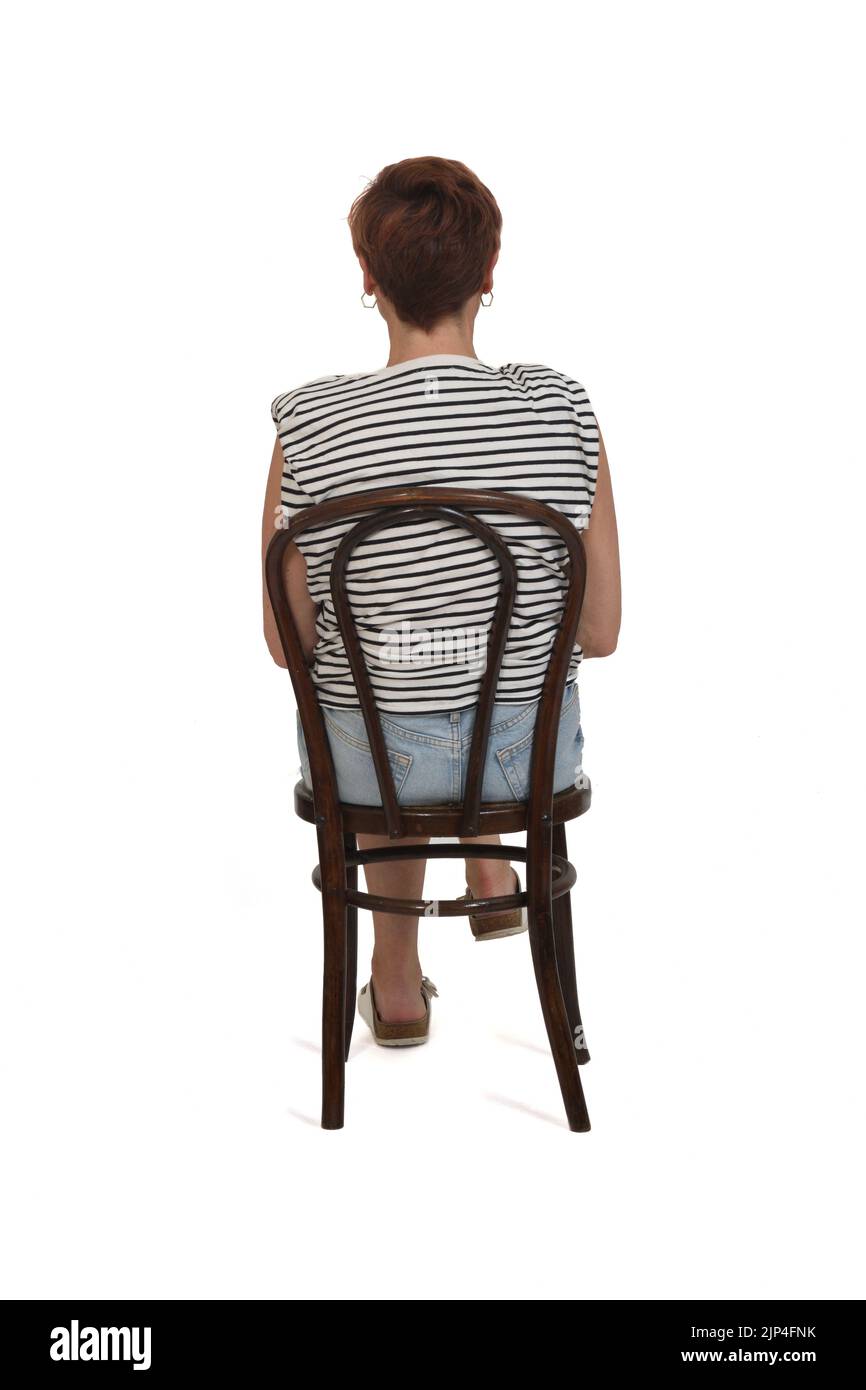 back view of middle aged woman sitting legs on chair legs crossed on ...