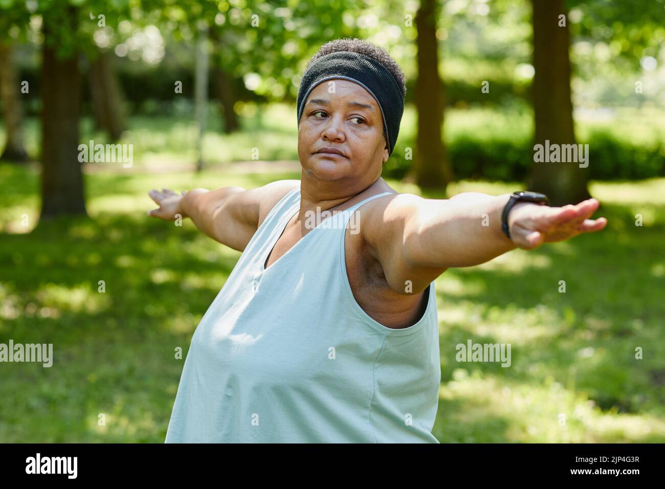 Waist up portrait of overweight black woman working out outdoors in ...