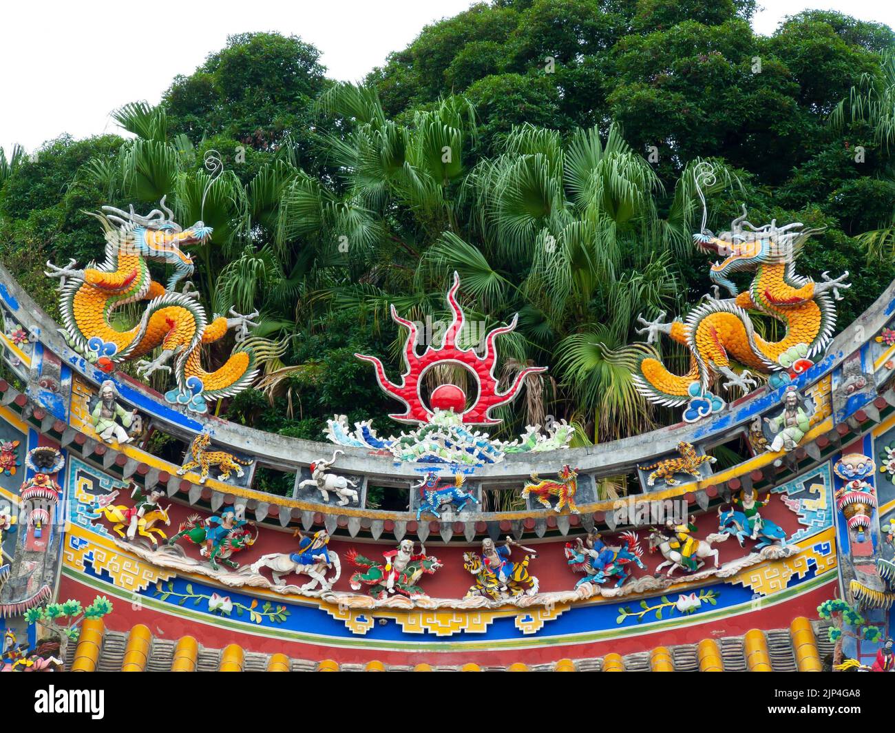 A close-up shot of the dragon decoration on the roof of a temple in ...