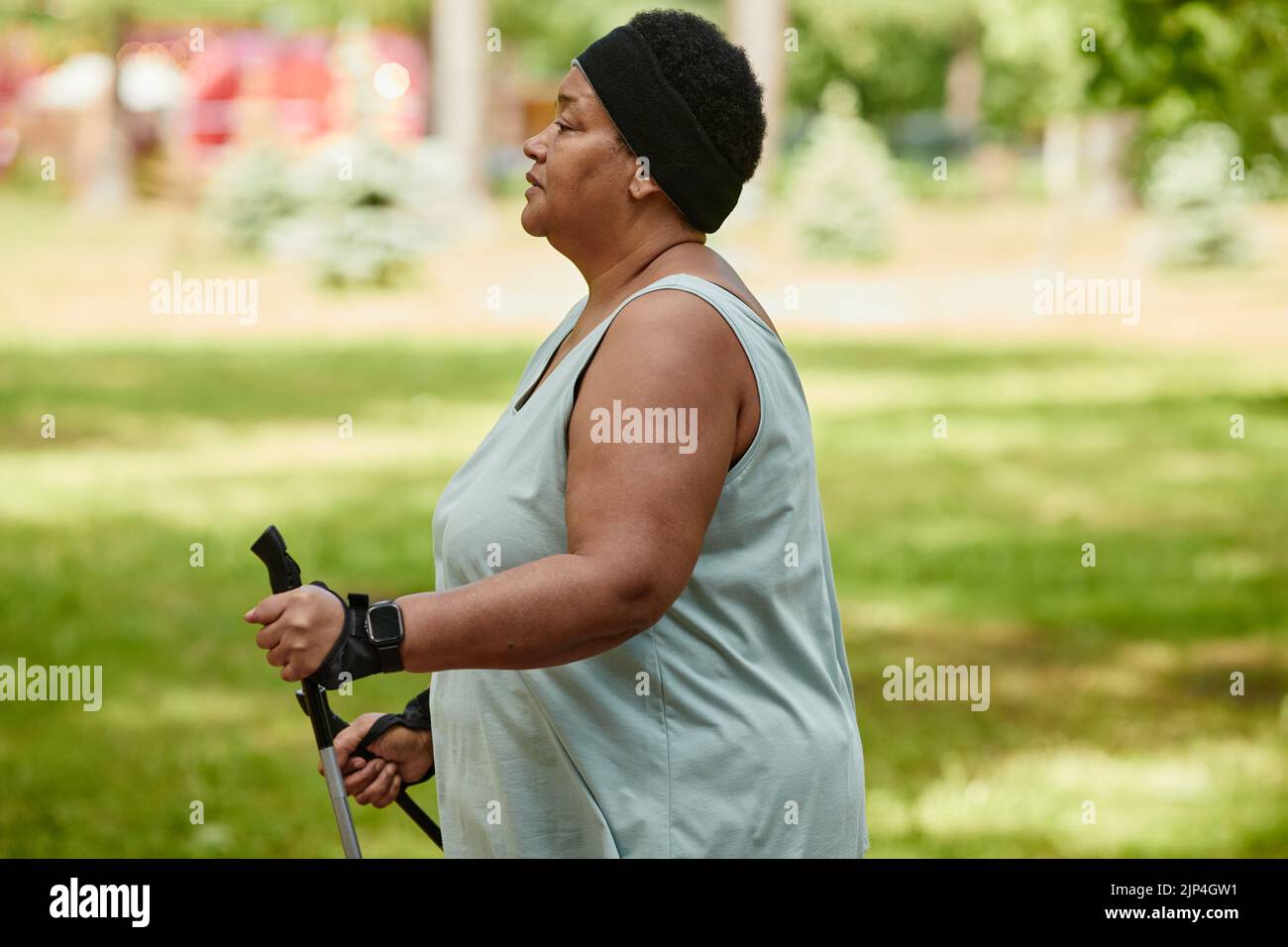 Side view portrait of overweight black woman walking outdoors with ...
