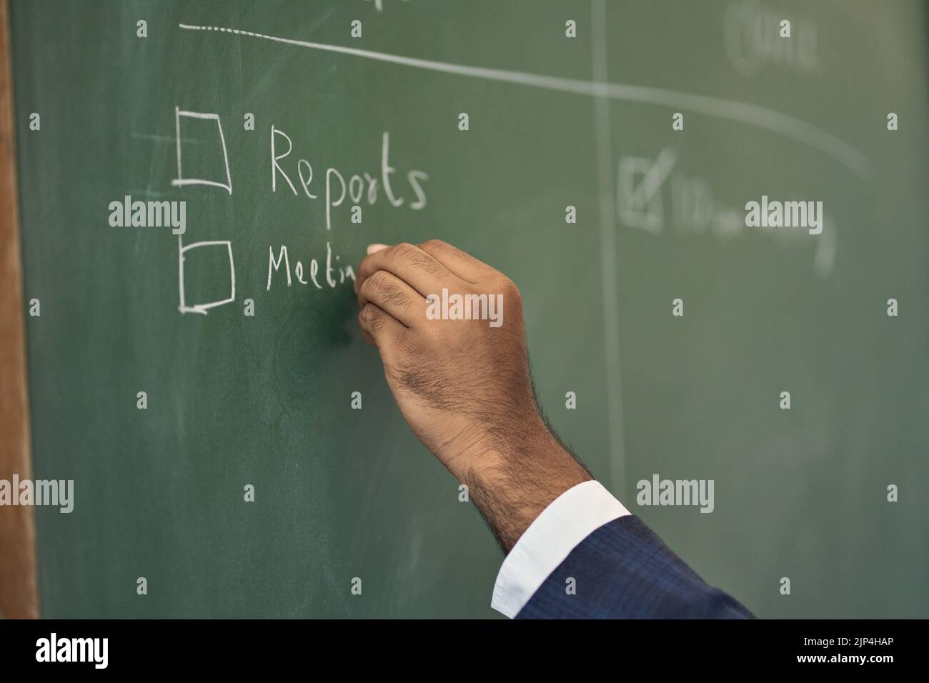 Business man writing work plan checklist on blackboard. Close up Stock ...