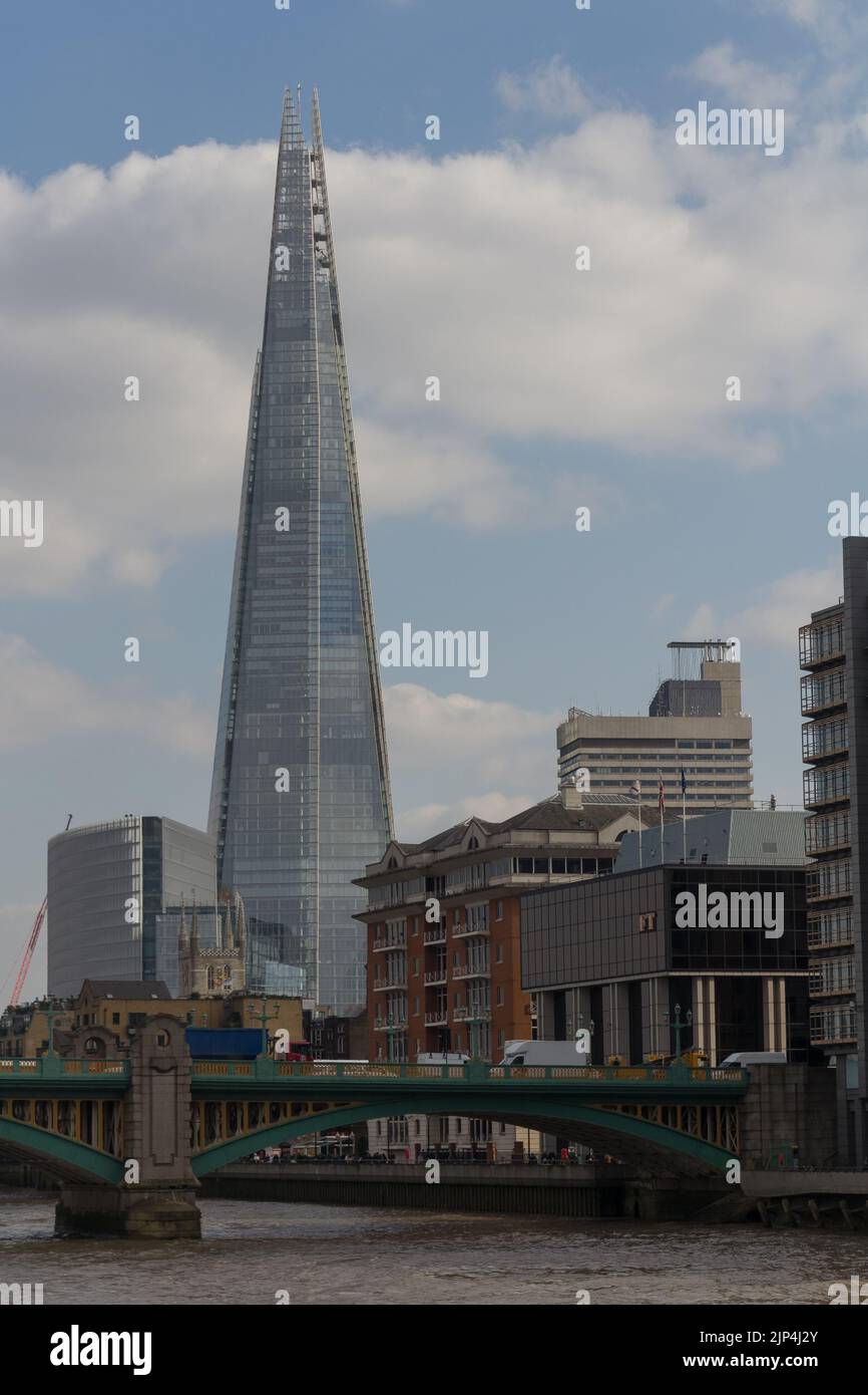 A vertical shot of a high-rise building under the cloudy sky in London ...