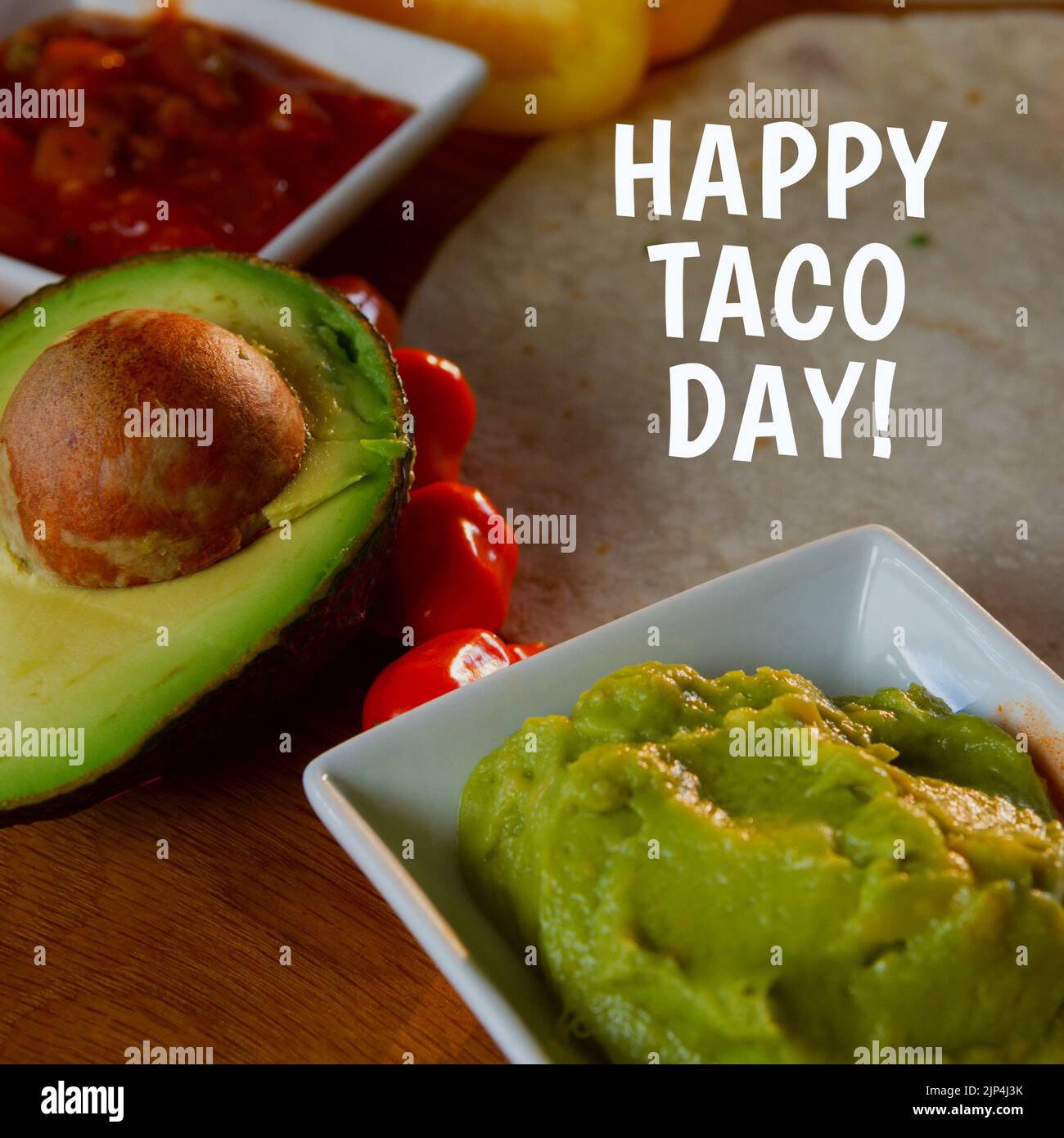 Composition of happy taco day text with tacos ingedients on table ...